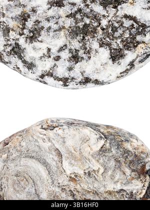Edges of two pebbles isolated on white background with a space for text ...