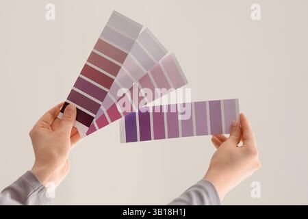 Female hands with violet paint palette swatches at home, closeup Stock ...