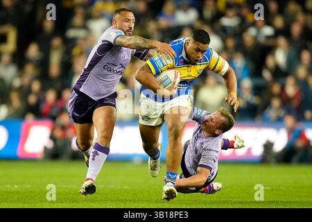 Leeds Rhinos' Sam Lisone (centre) is tackled by Warrington Wolves' Marc ...
