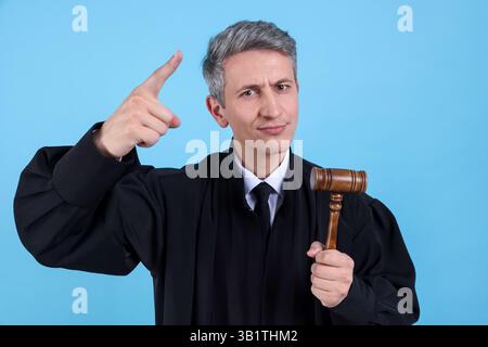 Judge with mallet on light blue background, closeup Stock Photo - Alamy