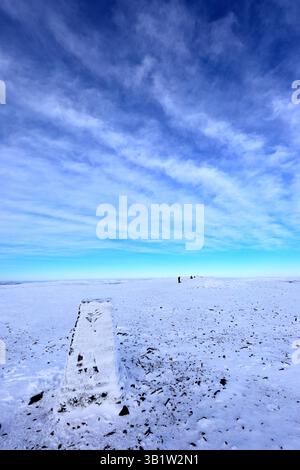 Winter snowy view of the OS Trig Point on the summit of Ingleborough ...