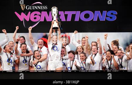 England's Zoe Aldcroft lifts the trophy as she celebrates with team ...