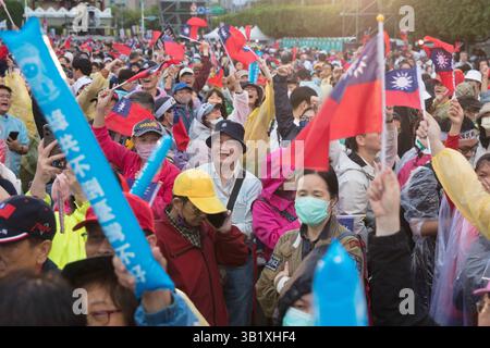 Supporters of the Kuomintang(KMT) wave flags and chant during a rally ...