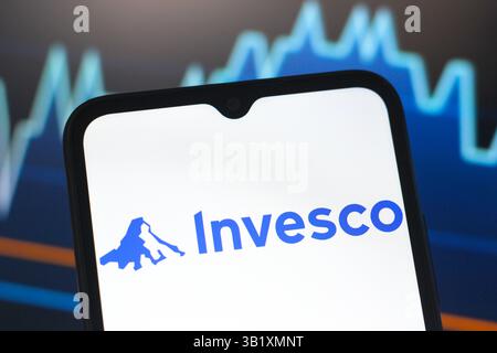 In this photo illustration, the Invesco logo is seen on a smartphone ...