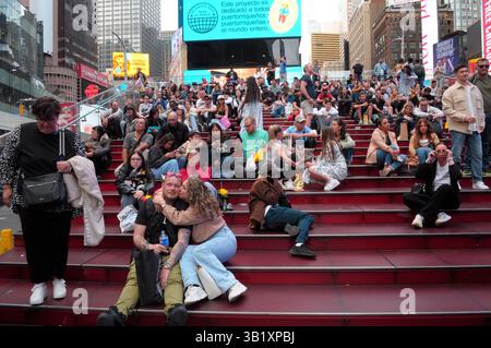 People are seen on the red stairs in Times Square, Manhattan, New York ...