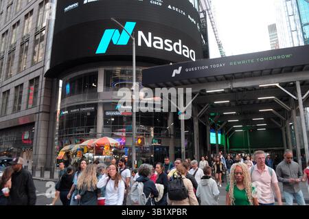 People walk past the Nasdaq MarketSite Times Square event space in ...