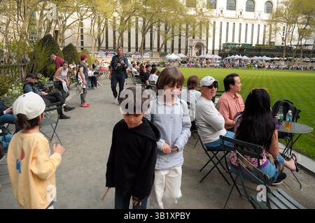 People walk in Bryant Park Winter Village, a seasonal holiday-themed ...
