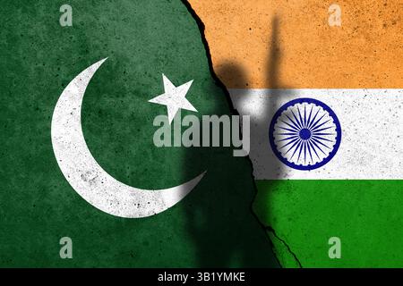 Flags of Pakistan and India painted on the concrete wall with soldier ...