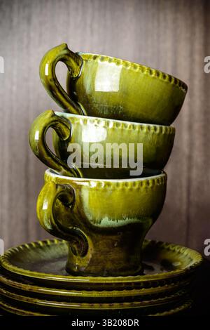 Three cups on saucers with sugar cubes, coffee and coffee beans on a ...