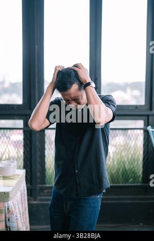 Worried black man suffering alone in emotional pain outside in city ...