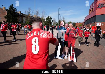 A Liverpool fan outside the ground with a cardboard cut out of manager ...