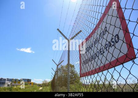 Translation: "Military zone, no entry." Barbed wire fence preventing ...