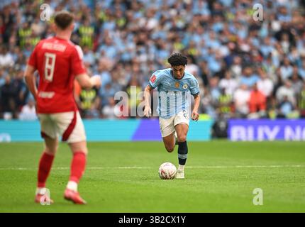 Rico Lewis Of Manchester City Brings the ball forward during the ...