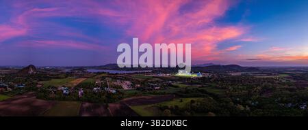 Wide panoramic view of a dramatic fiery sunset with vivid red and ...