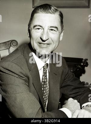 Ted Geisel (Dr. Seuss) (1904-1991) seated at desk covered with his ...