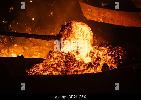 Removing slag from surface of hot iron in melting furnace Stock Photo ...