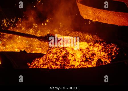 Removing slag from surface of hot iron in melting furnace Stock Photo ...