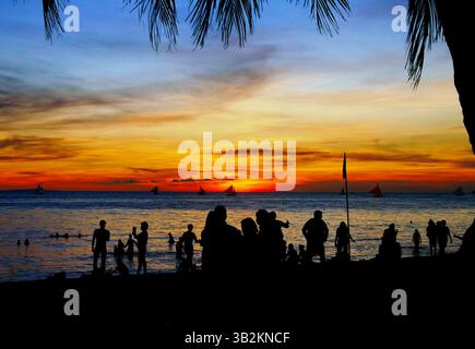 Vacationers enjoy the scenic sunset and tranquil waters at Boracay ...