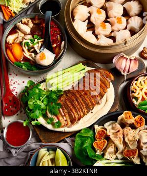 A top view of assorted dim sum served in bamboo steamers and ceramic ...