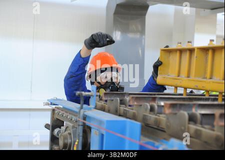 Workers fix and prepare layers of cathode copper at the plant Stock ...