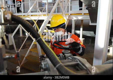 Workers fix and prepare layers of cathode copper at the plant Stock ...