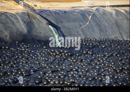 The chemical tank is covered with plastic balls to slow evaporation at ...
