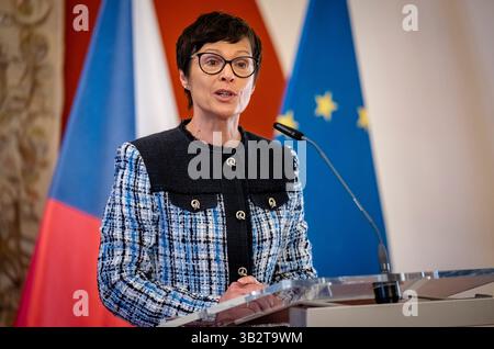EU Commissioner for Enlargement Marta Kos, front, looks at a production ...