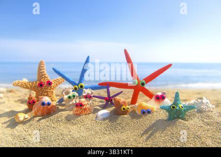Funny shells with eyes at the beach with the sea in the background ...