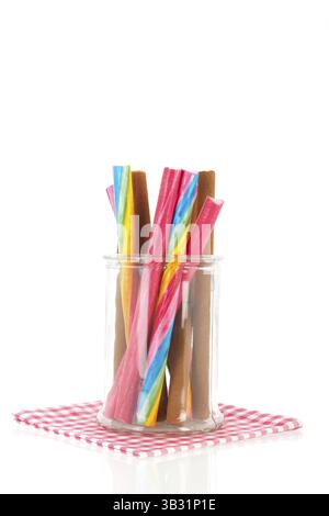 Glass pot of colorful candy canes isolated over white background Stock ...