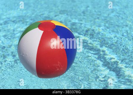 Inflatable colorful beach ball floating in water Stock Photo - Alamy