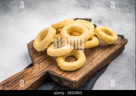 Raw and frozen squid rings with breading, uncooked calamari snack ...
