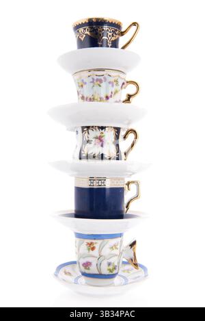 Stacked cups and saucers isolated over white background Stock Photo - Alamy