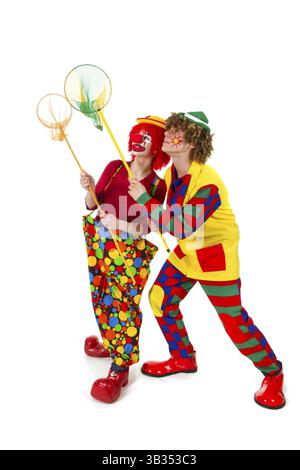Couple funny full dressed clowns are catching it all Stock Photo - Alamy