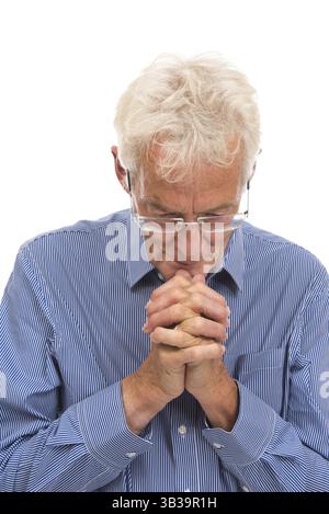 Portrait praying senior man against white background Stock Photo - Alamy