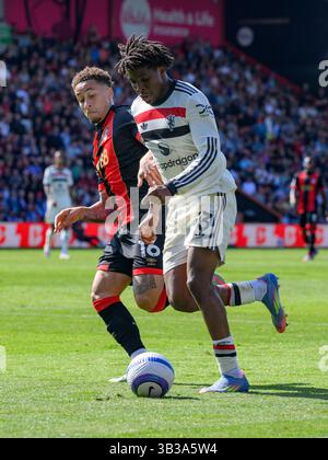 Manchester United's Patrick Dorgu, left, fights for the ball with ASEAN ...
