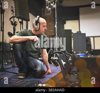 event technician preparing the stage, sound and light for an event ...