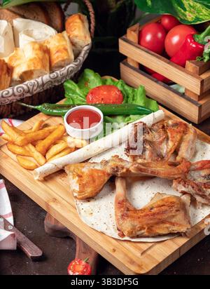 Baked chicken wings with French fries on wooden table Stock Photo - Alamy