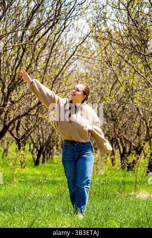 scenic picture of beautiful blond girl in black dress by the window ...