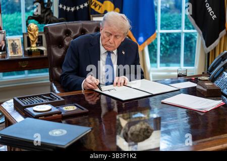 US President Donald J. Trump signs an executive order during a ceremony ...