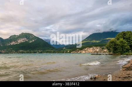 Lake Annecy under dramatic sky with the Alps at the background Stock ...