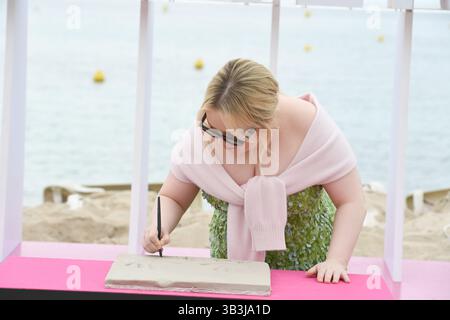 Nicola Coughlan writes on cement during the "Prix Konbini de l ...