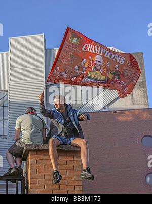 A Liverpool fan holds a scarf during the English Premier League soccer ...