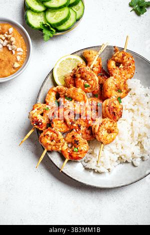 Grilled shimp prawn satay skewers with steamed rice, peanut sauce and ...