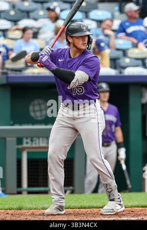 Colorado Rockies' Hunter Goodman (15) follows through on hitting a ...