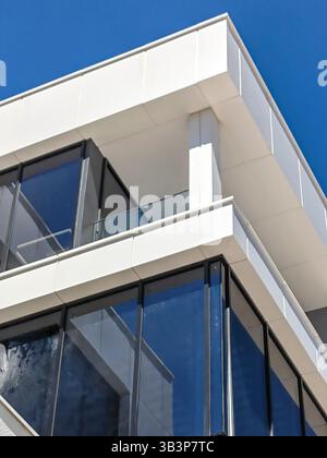 A vertical low-angle shot of a white building against the background of ...
