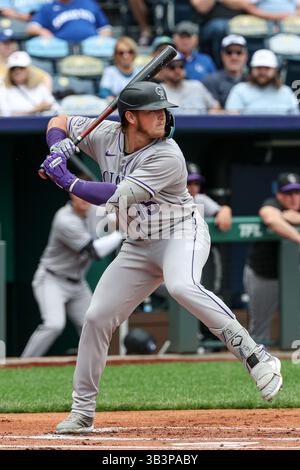 Colorado Rockies' Hunter Goodman (15) follows through on hitting a ...
