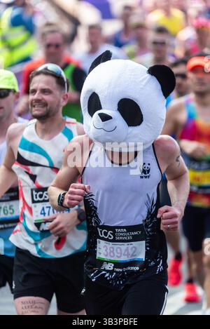 Matt Webster competing in the 2025 TCS London Marathon, passing through ...