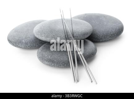 Acupuncture needles and spa stones isolated on white Stock Photo - Alamy