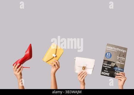 Female hands with magazine, high heel and stylish bags on grey ...