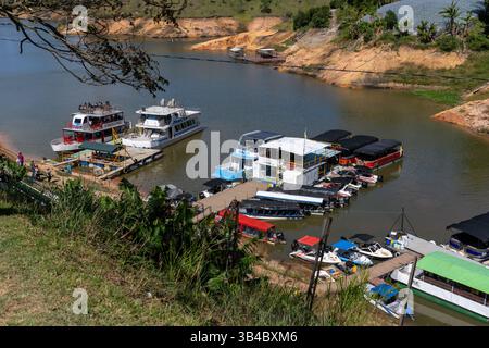 Tour boats at a dock on the Embalse Del Peñol or Guatape-Penol Reservoir in Colombia Stock Photo ...